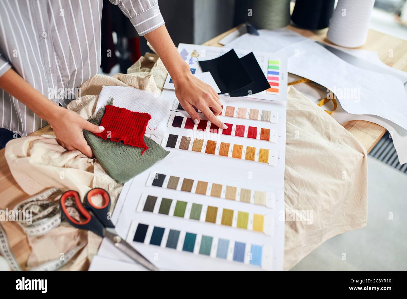 talented designer selecting colours for new garment, close up photo ...