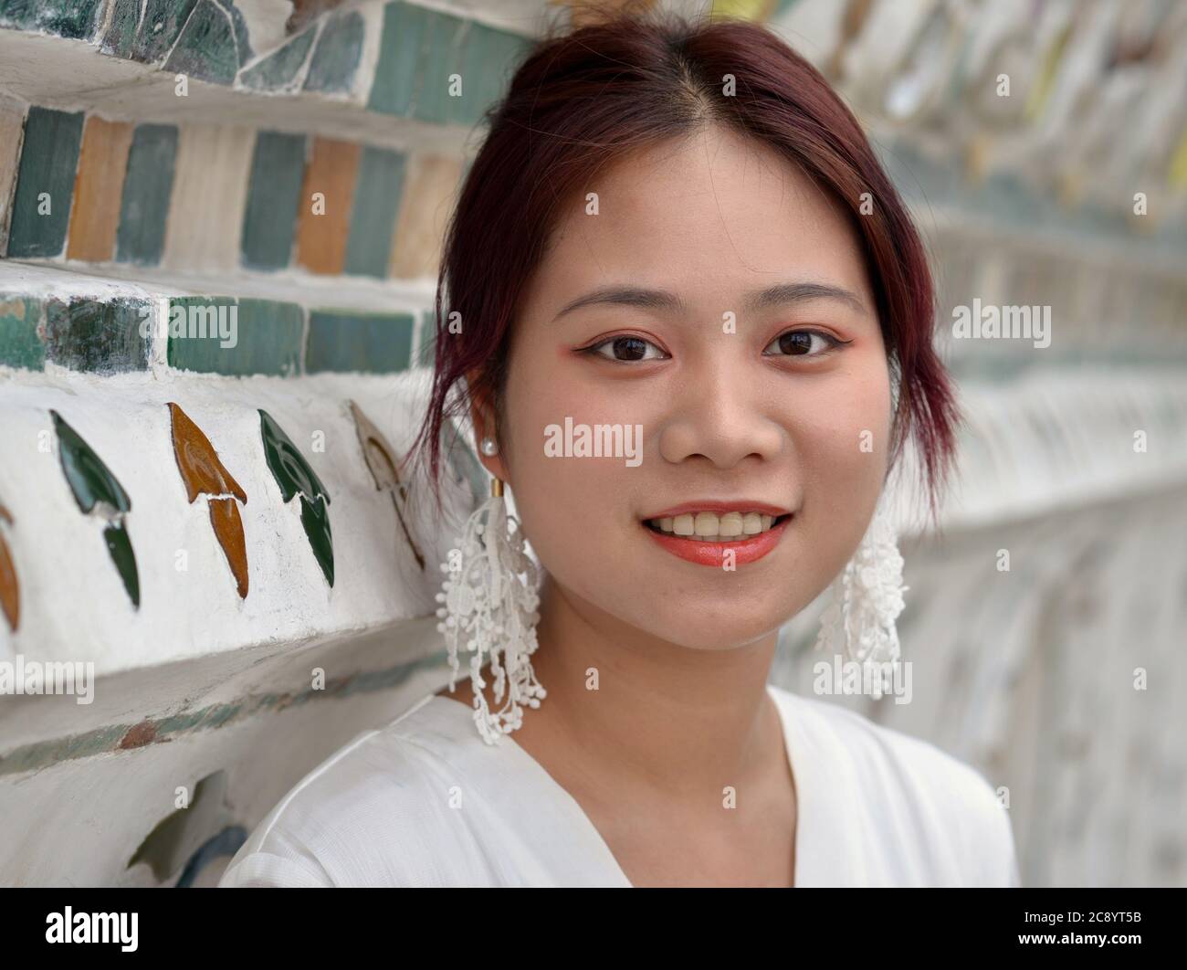 Beautiful young Southeast Asian woman smiles for the camera at Bangkok ...