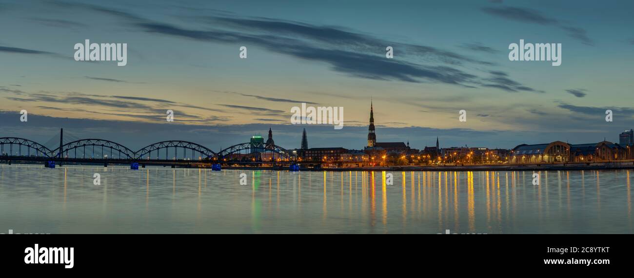 Night view on the illuminated riverside with reflection on the river in ...