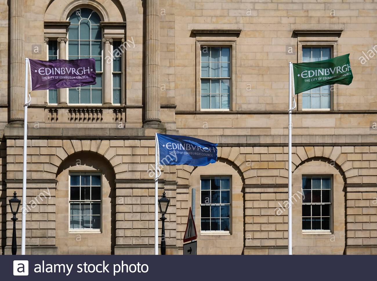 Three coloured City of Edinburgh Council flags flying in the breeze ...