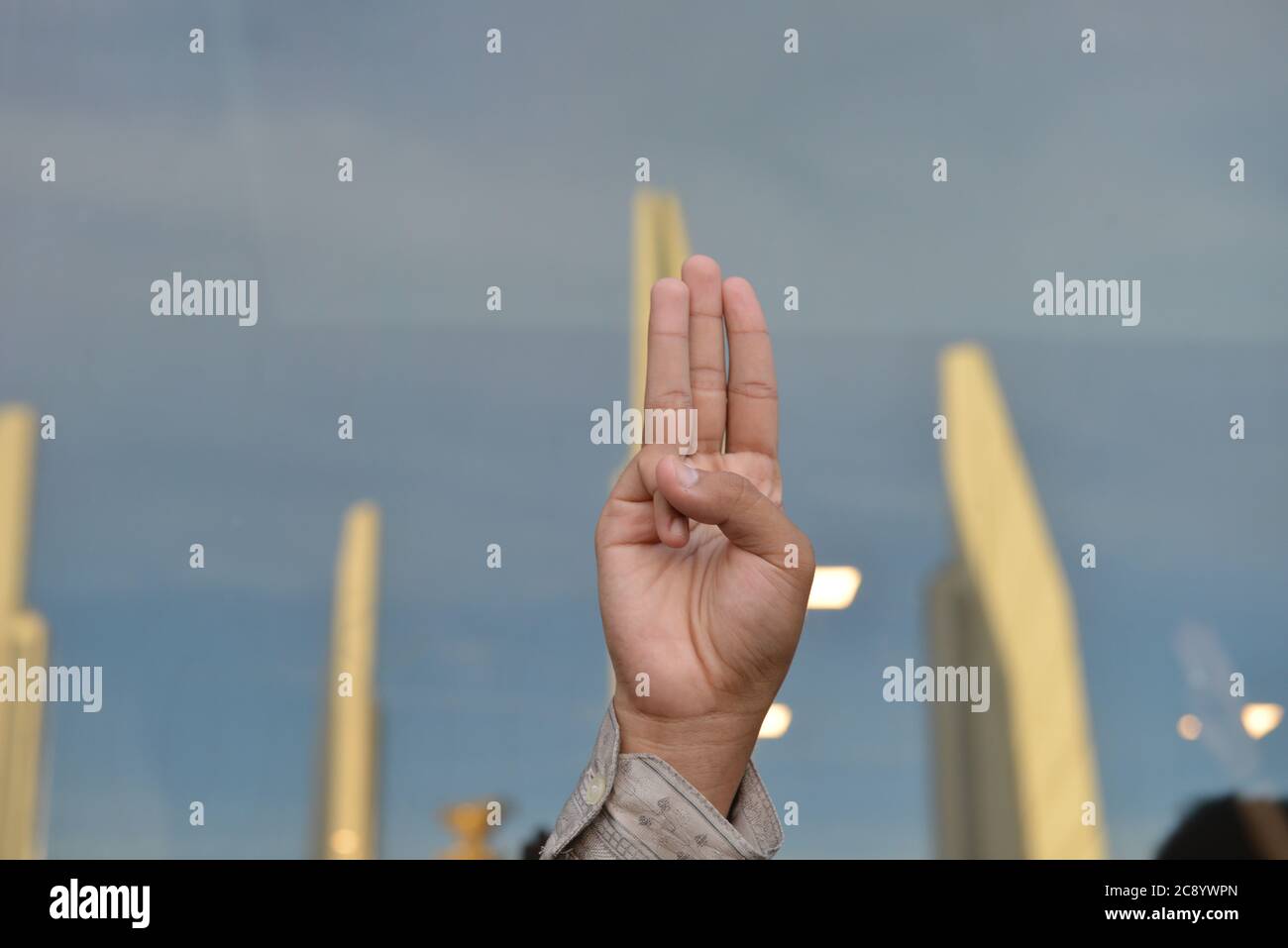 Demonstrators use hands to display democratic symbols. In a rally in ...