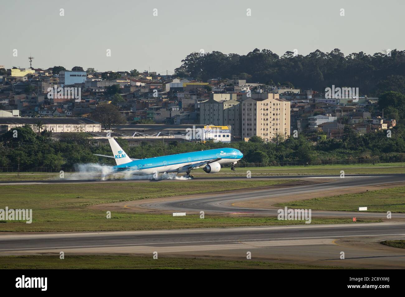 KLM Boeing 777-306ER (Reg. PH-BVN) smoking the main landing gear tires ...