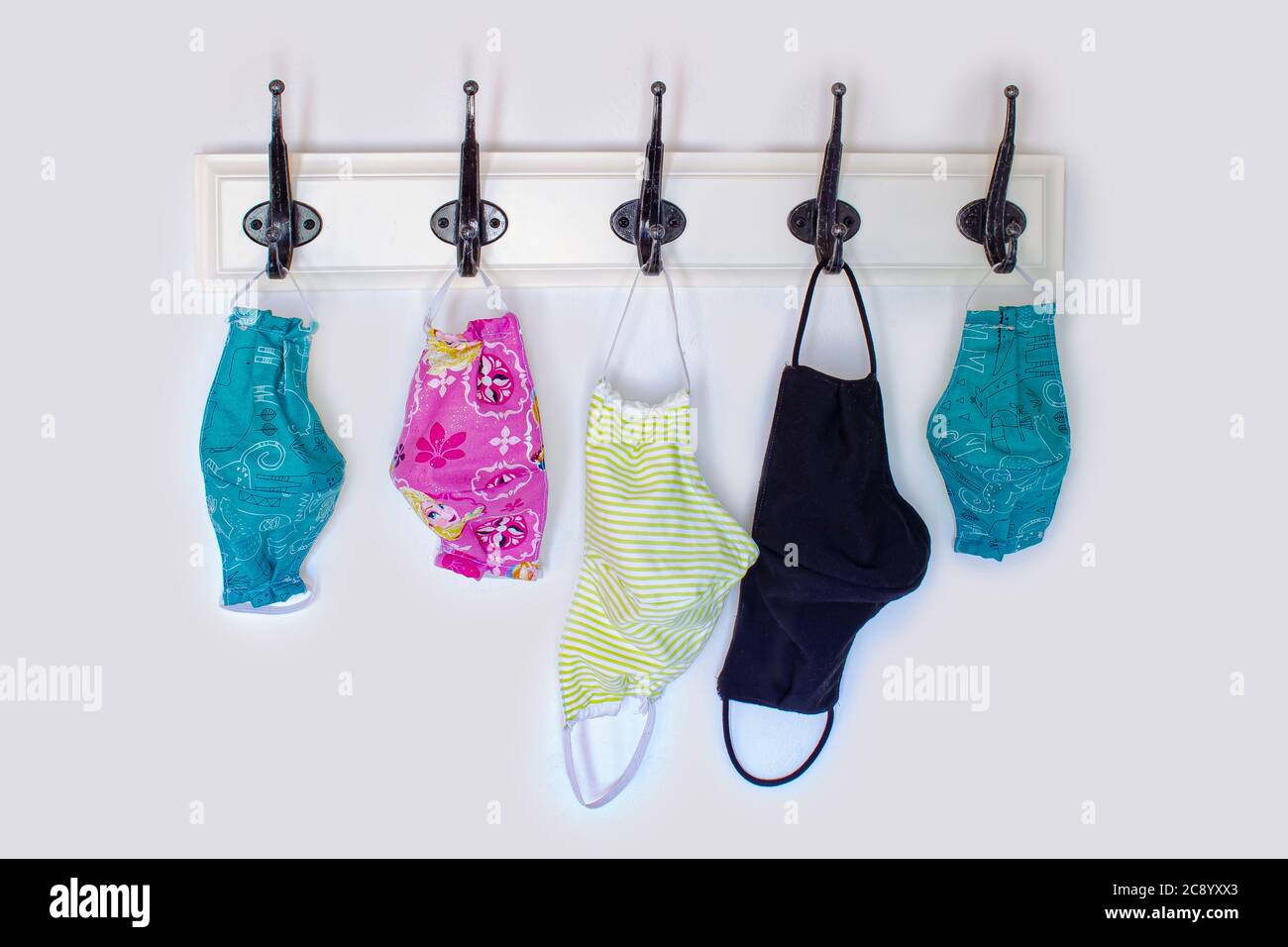 Family house face masks on a Wall Hook or Coat Rack on a white wall ...