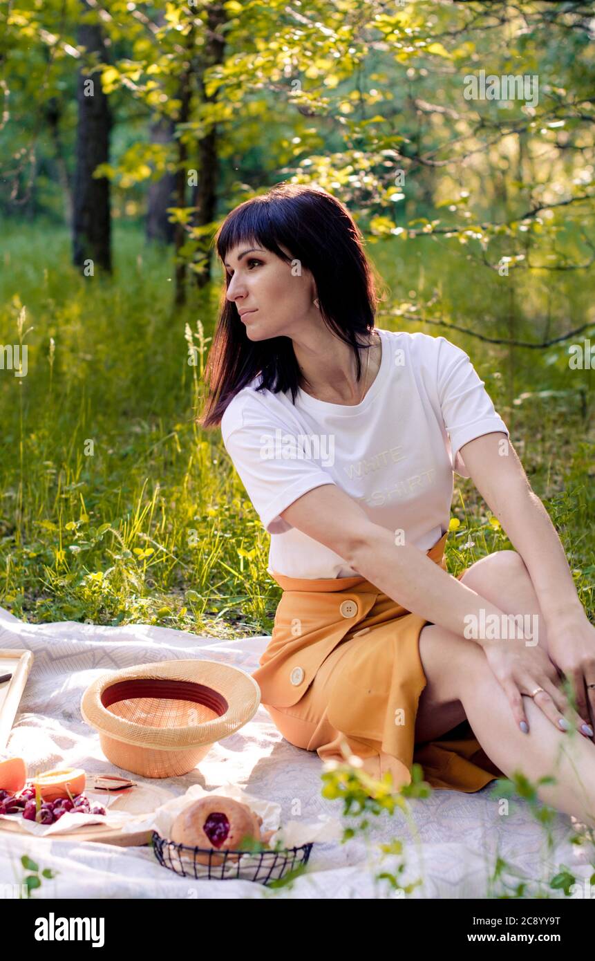 Girl on a picnic in at summer green park Stock Photo - Alamy