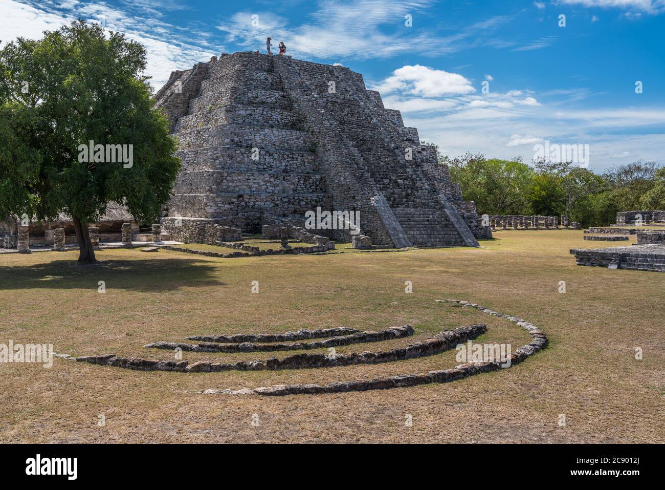 Tourist on top of the Pyramid of Kukulkan or the Castillo in the ruins ...