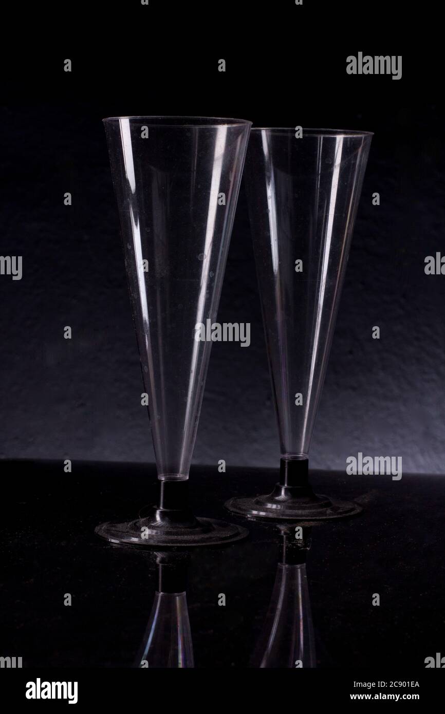 Two transparent glasses shot in low-key lighting isolated over the ...