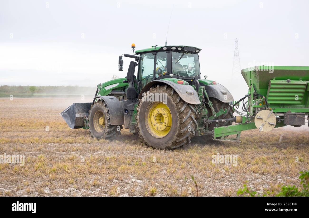 Tractor spreading fertilizer on a field Stock Photo - Alamy