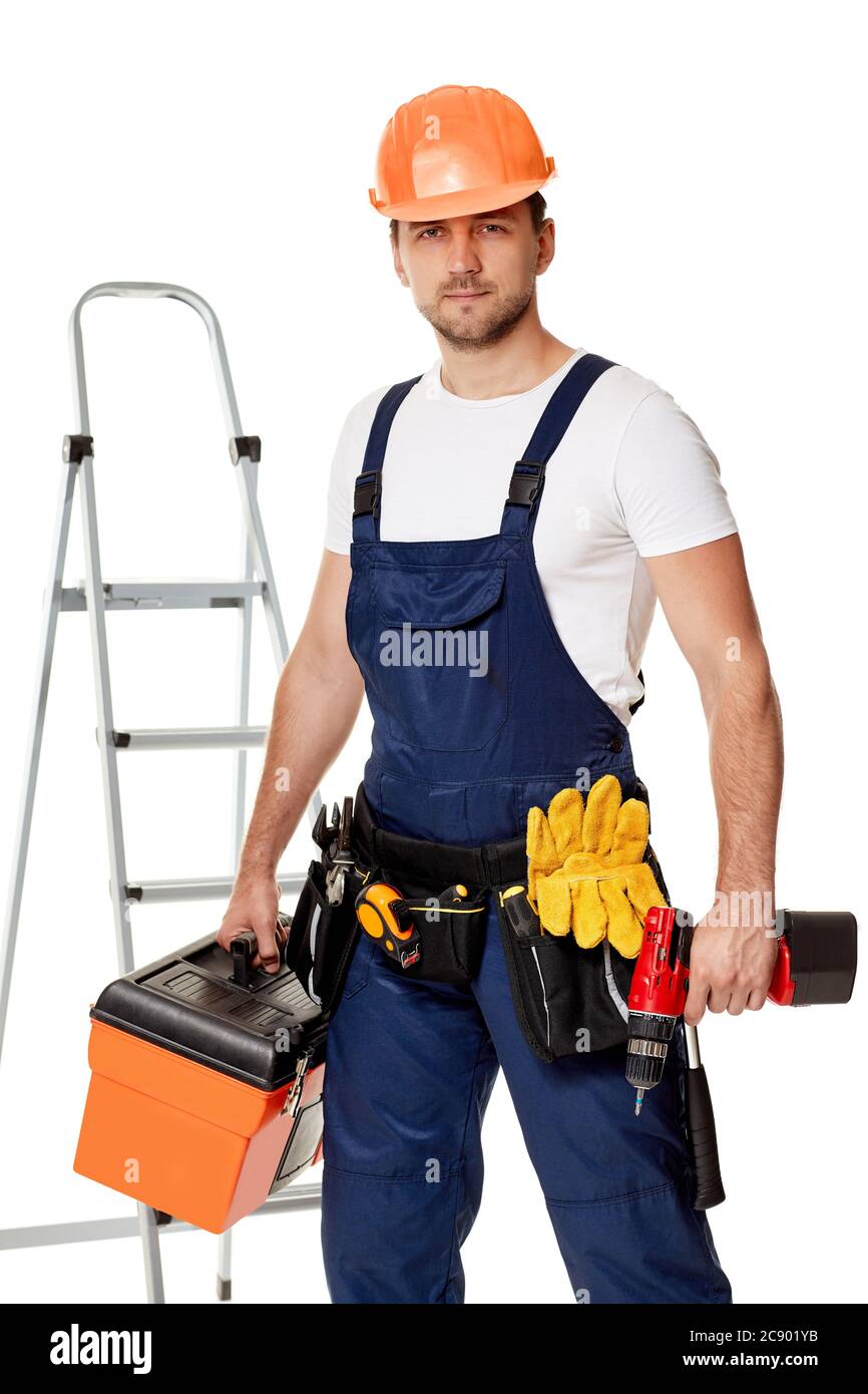 caucasian repairman worker in uniform and helmet holding cordless ...