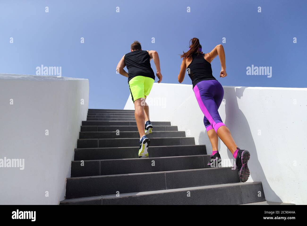 Couple running up stairs at fitness gym. Healthy active lifestyle sport ...