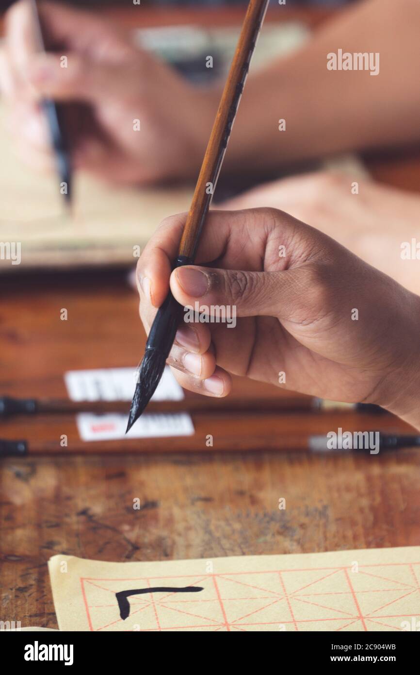 Hand holding traditional writing brush hi-res stock photography and ...