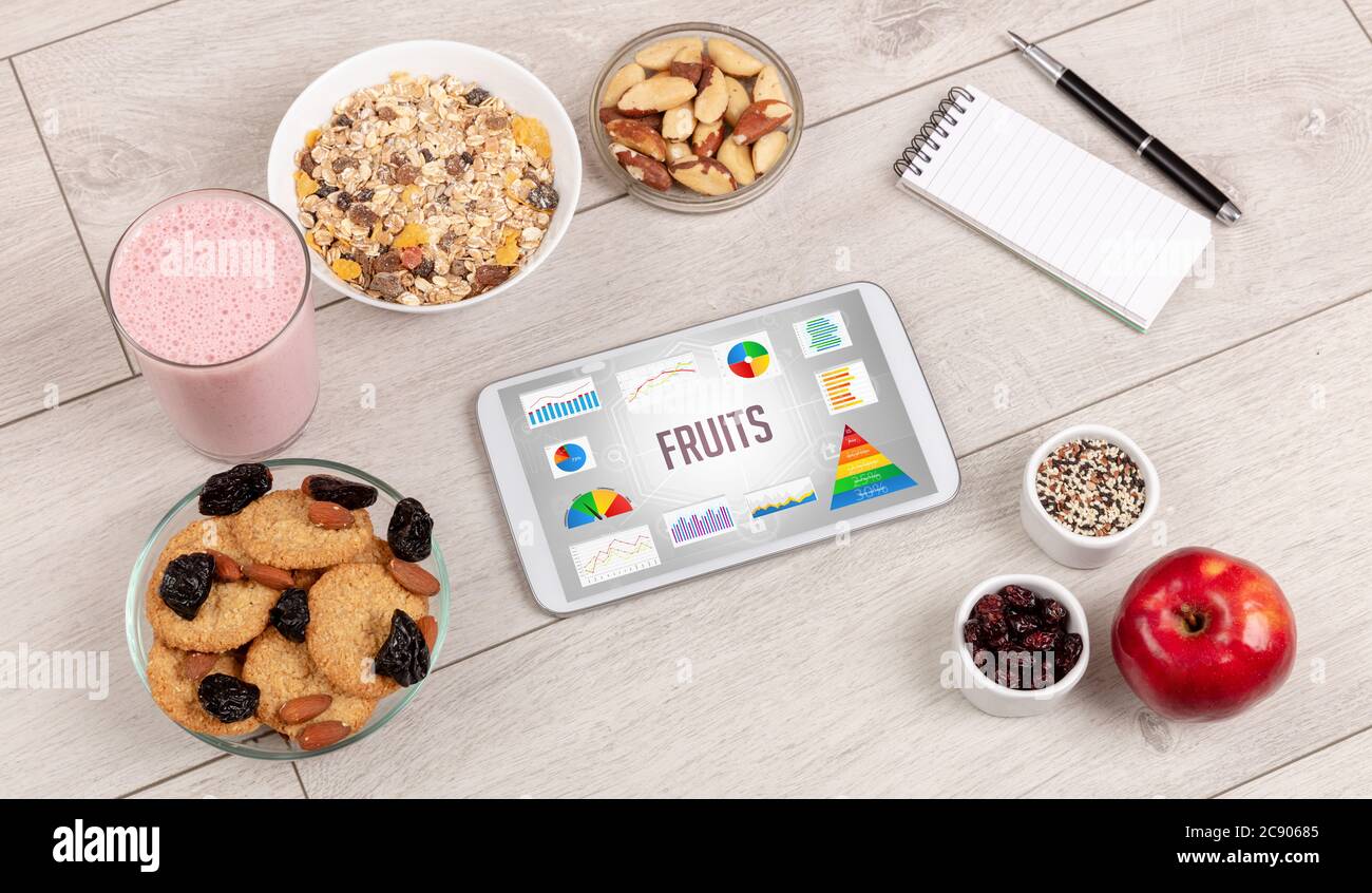 Organic food and tablet pc showing FRUITS inscription, healthy ...