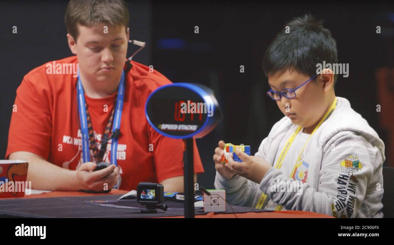 THE SPEED CUBERS, a young speedsolver (right) at a Rubik s Cube ...