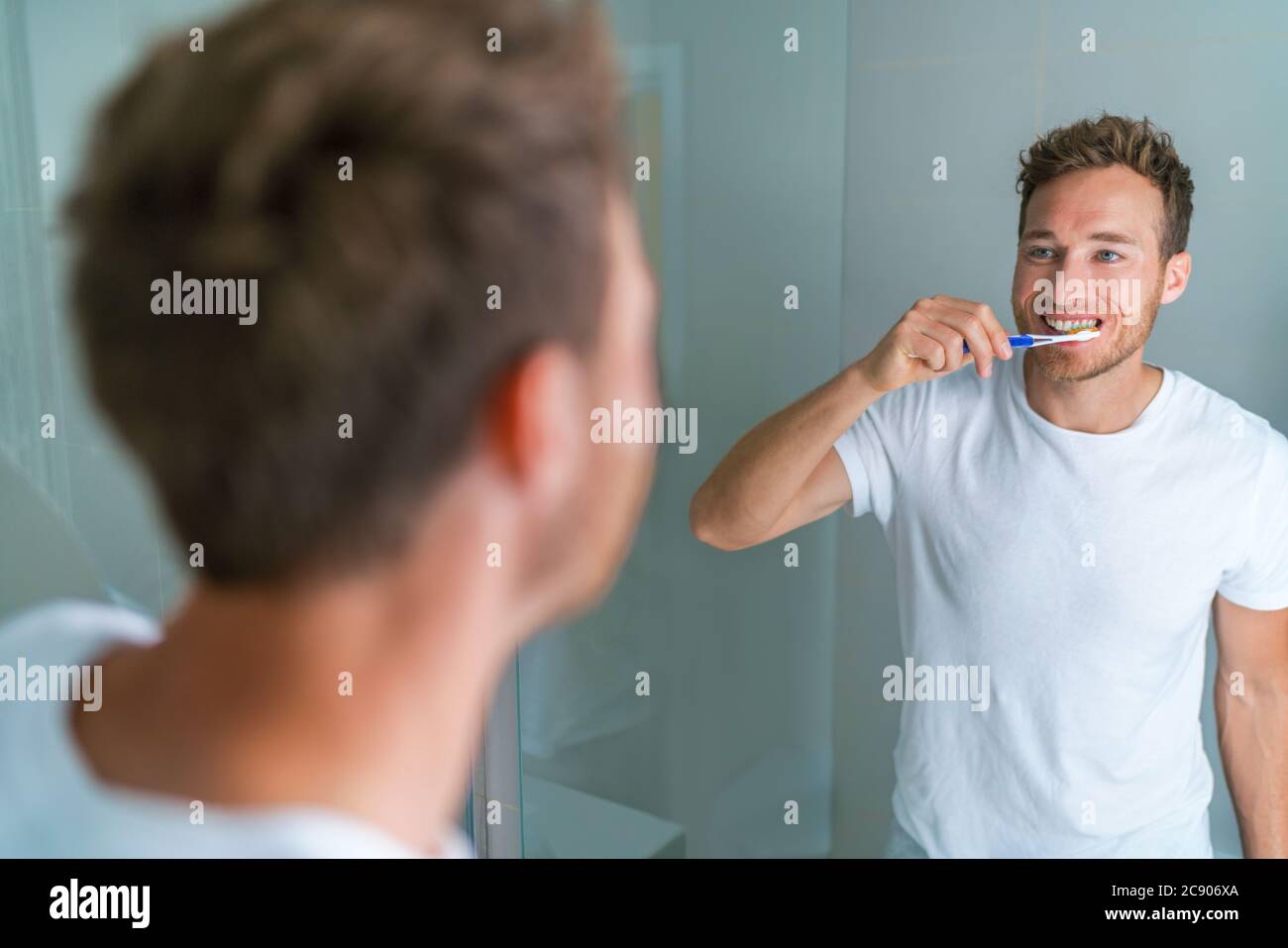 Man Brushing Teeth In Mirror