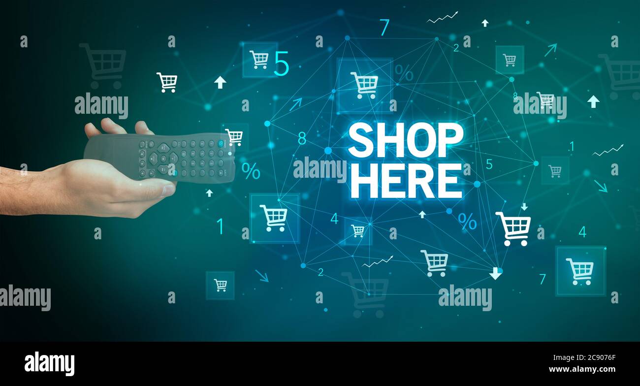 hand holding wireless peripheral with SHOP HERE inscription, online ...