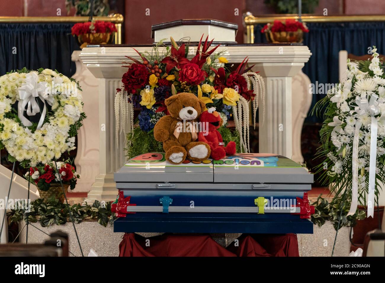 New York, NY - July 27, 2020: Two stuffed animals sit on the casket of ...