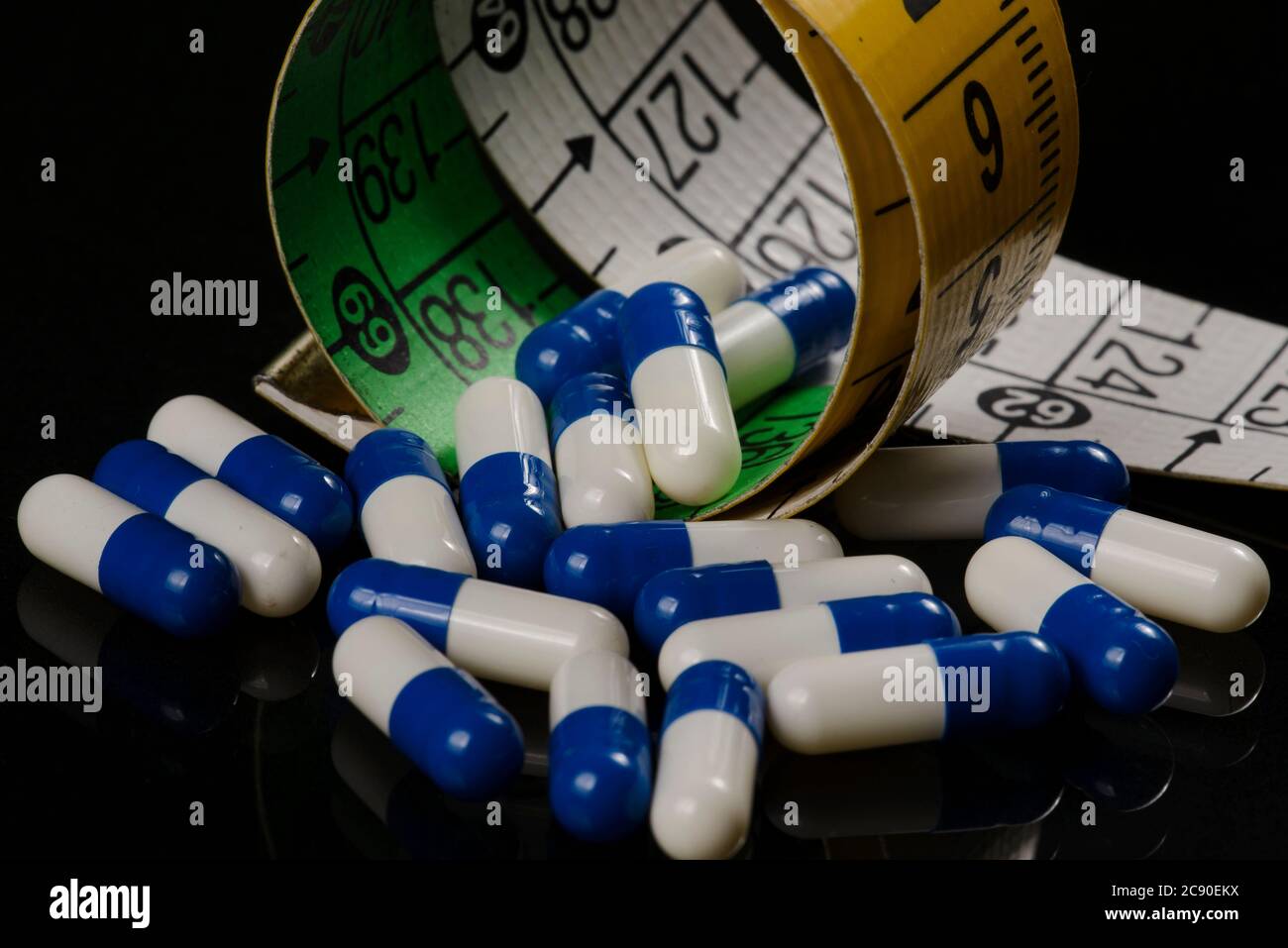 Medicine capsules and measuring tape symbolizing obesity treatment ...