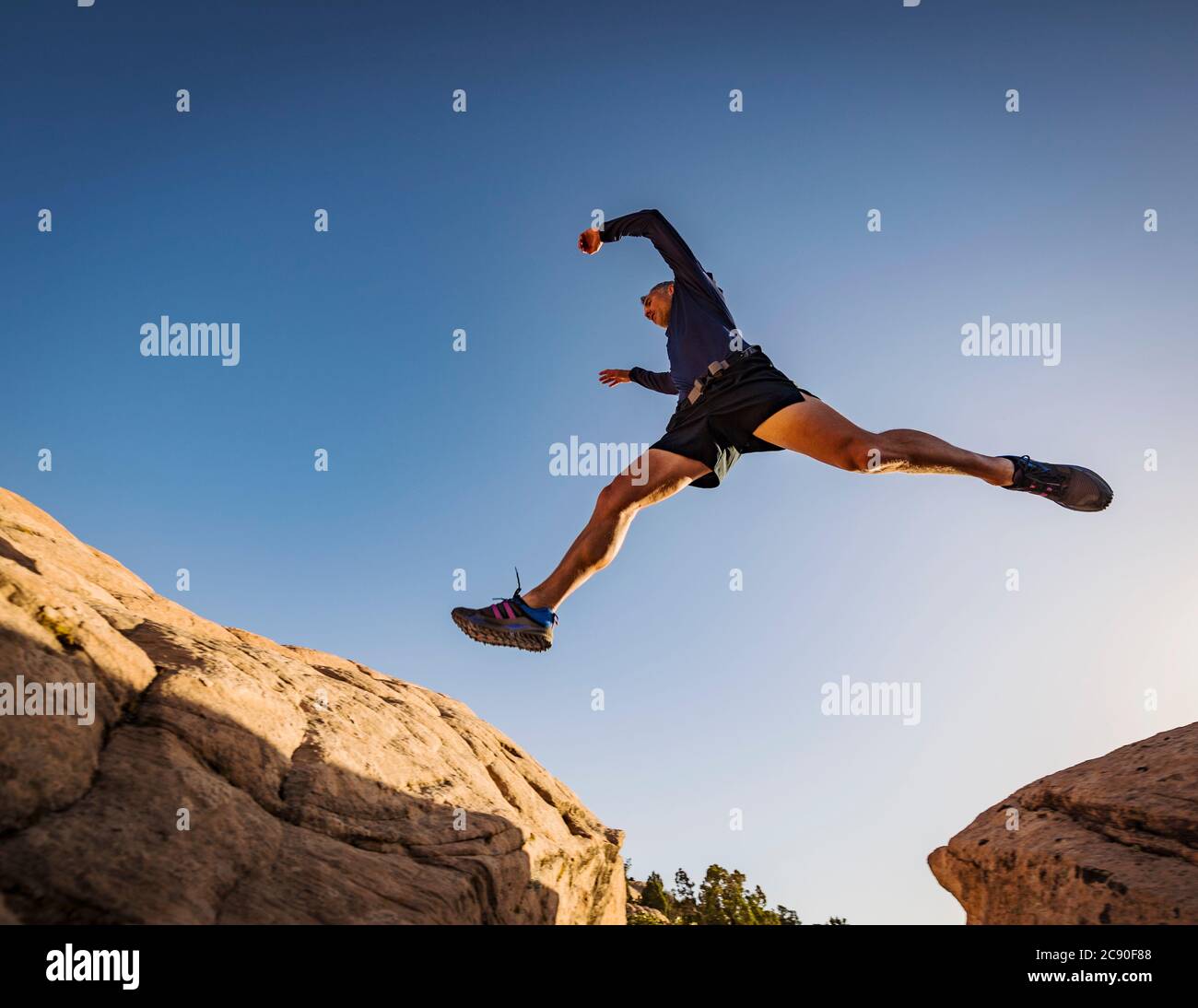 Man jumping over rocks hi-res stock photography and images - Alamy