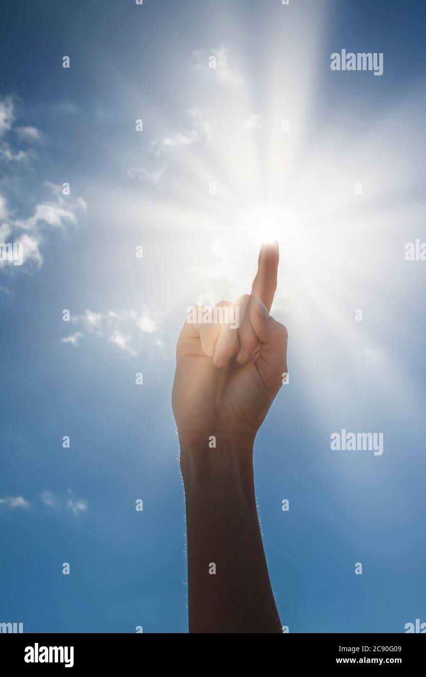 Woman's hand pointing towards sun Stock Photo - Alamy