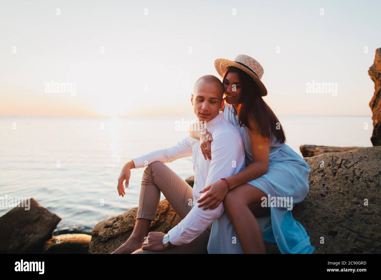 Romantic couple on beach at sunset Stock Photo - Alamy