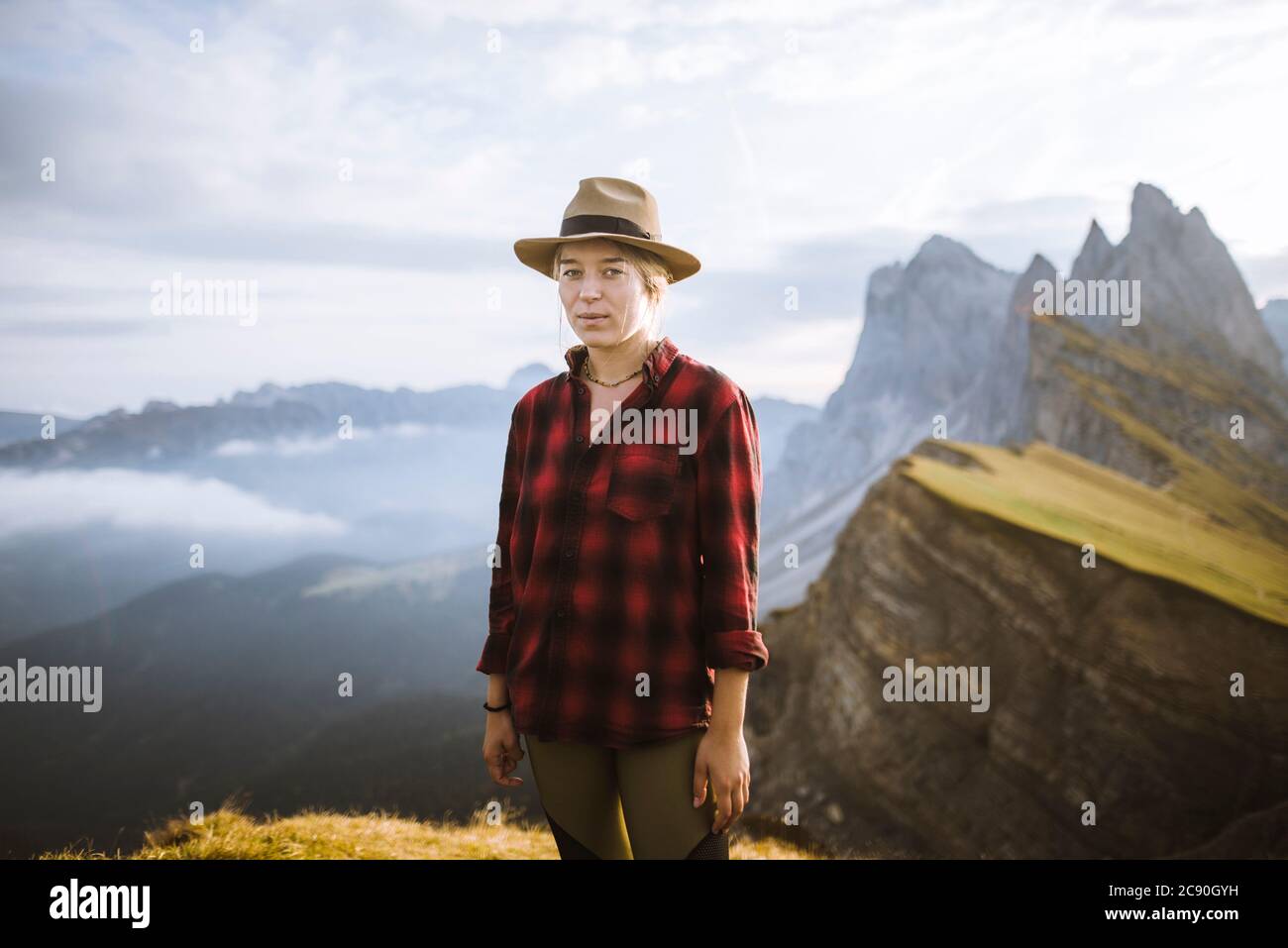 Italy, Dolomite Alps, Seceda mountain, Portrait of woman in hat hiking ...