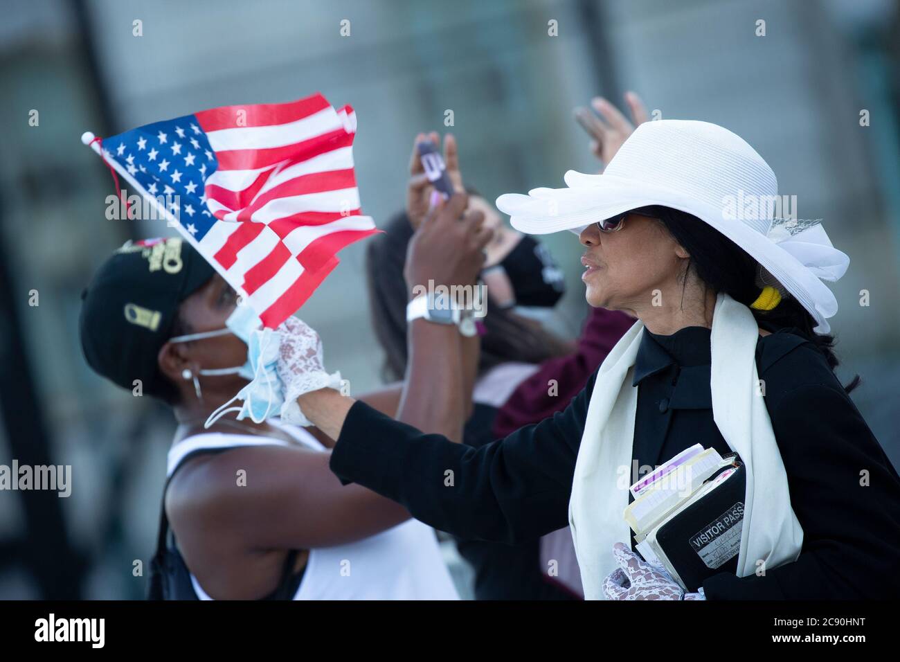 Mary Clement, an Evangelist from Silver Spring, waves the American flag ...