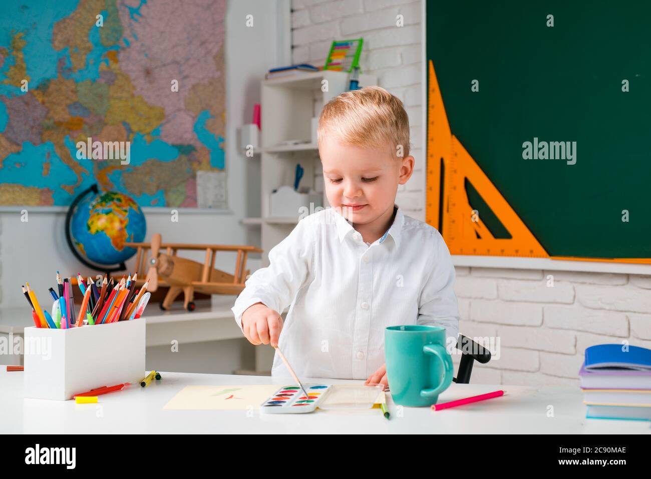 Back to school. School interiors. School kids against green chalkboard ...
