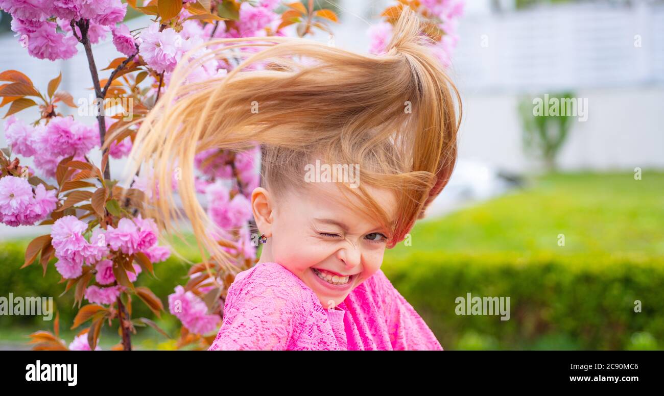 Crazy spring teenager girl in fragrant pink flowers in summer blossom ...