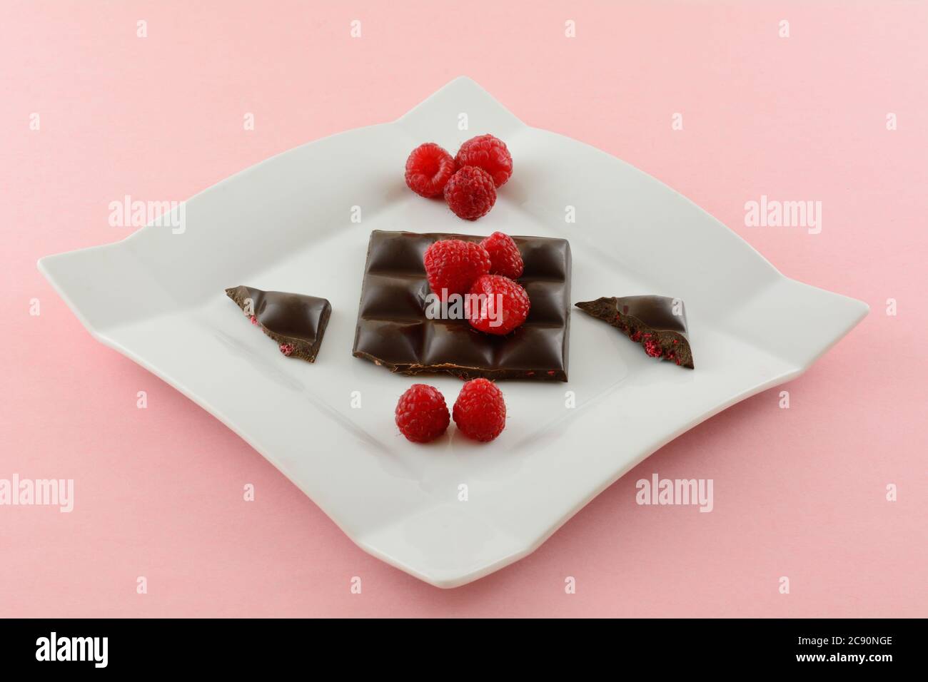 Dark chocolate candy bar with bits of raspberry and fresh raw red ...