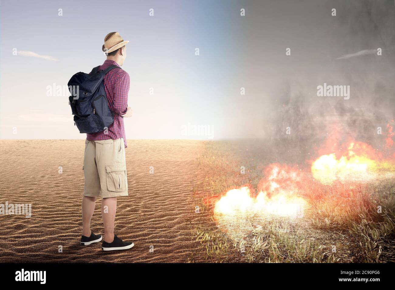 Asian man with backpack looking at burning ground on the field. Concept ...
