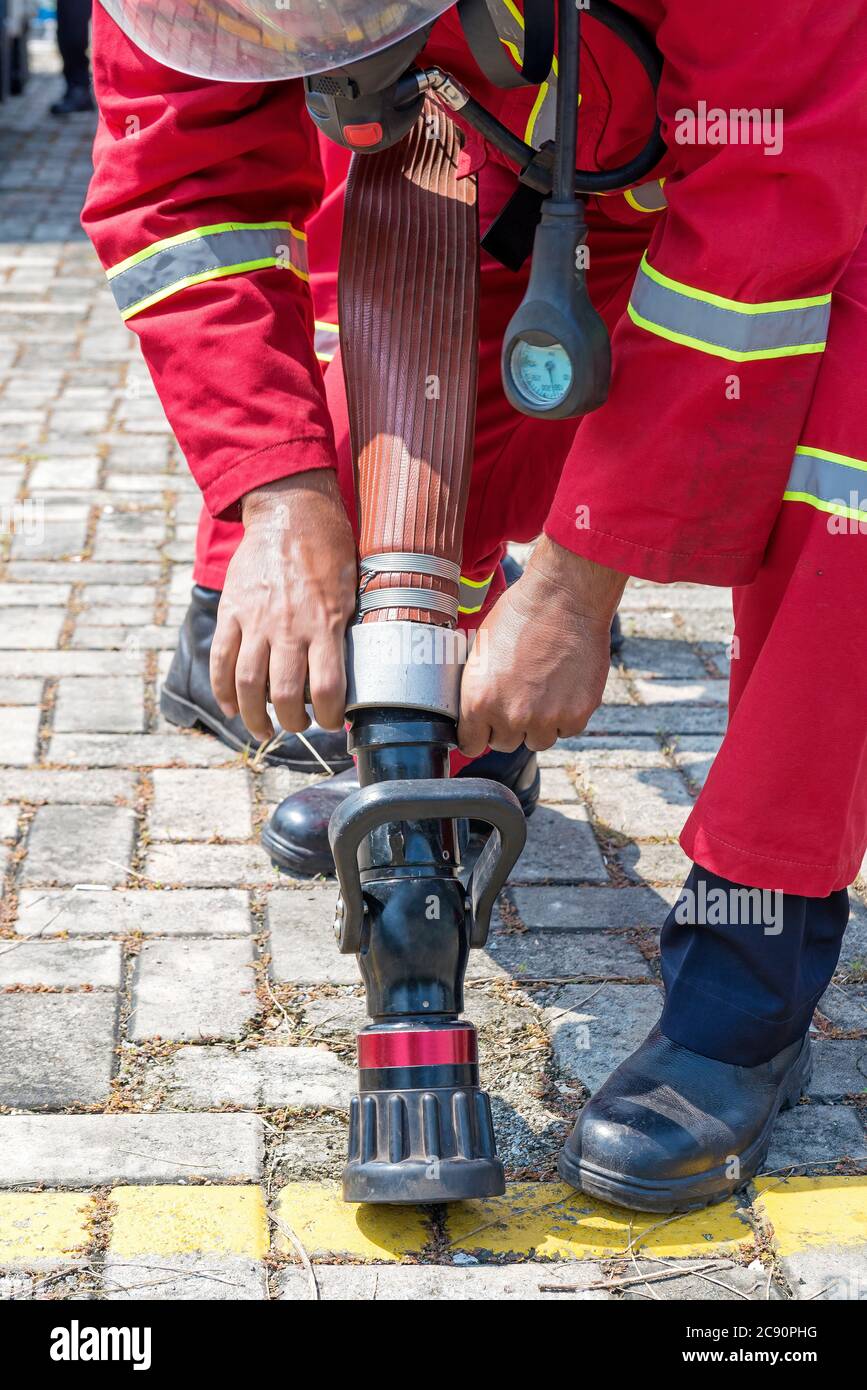 Firefighters holding water hose hi-res stock photography and images - Alamy