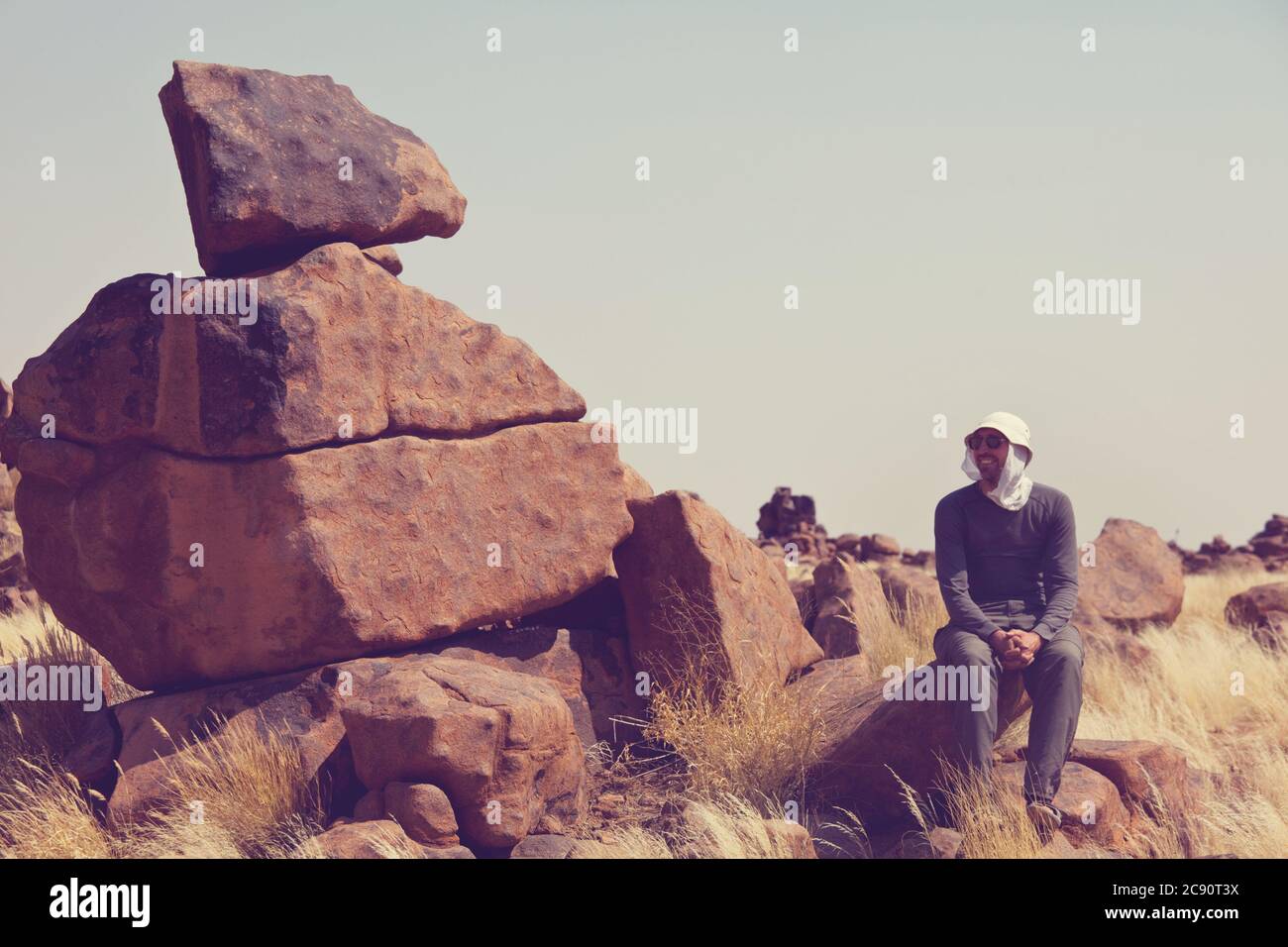Tourist in Ancient Giant's Playground labyrinth, stacked stones and ...