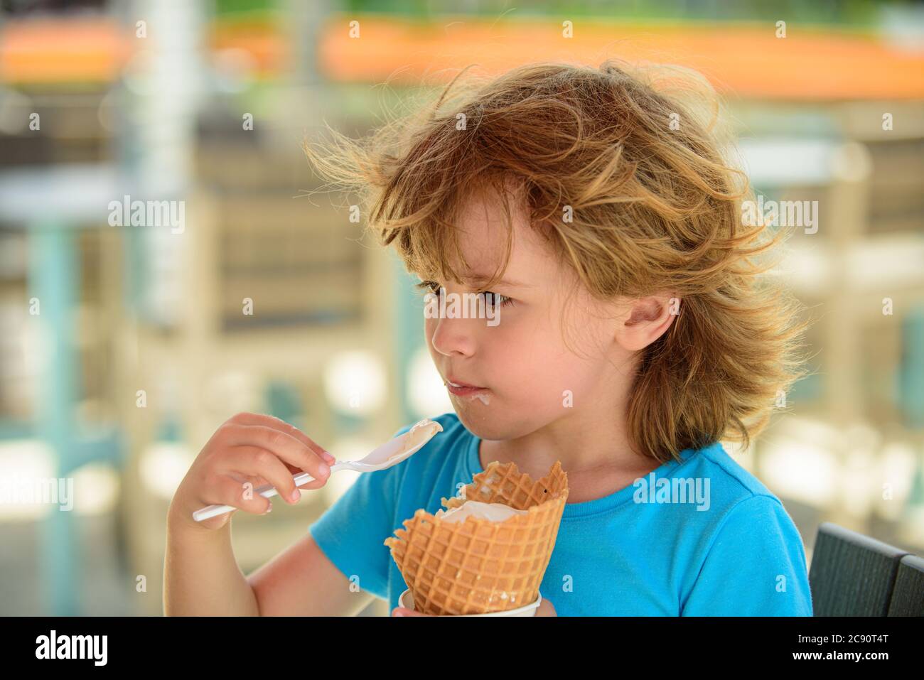 Beautiful little boy eats ice cream in the summer Stock Photo - Alamy