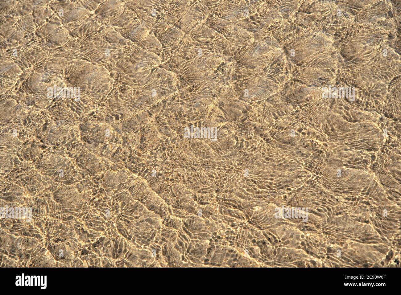 Surface of sea water with ripples on beach sand. Water surface ...