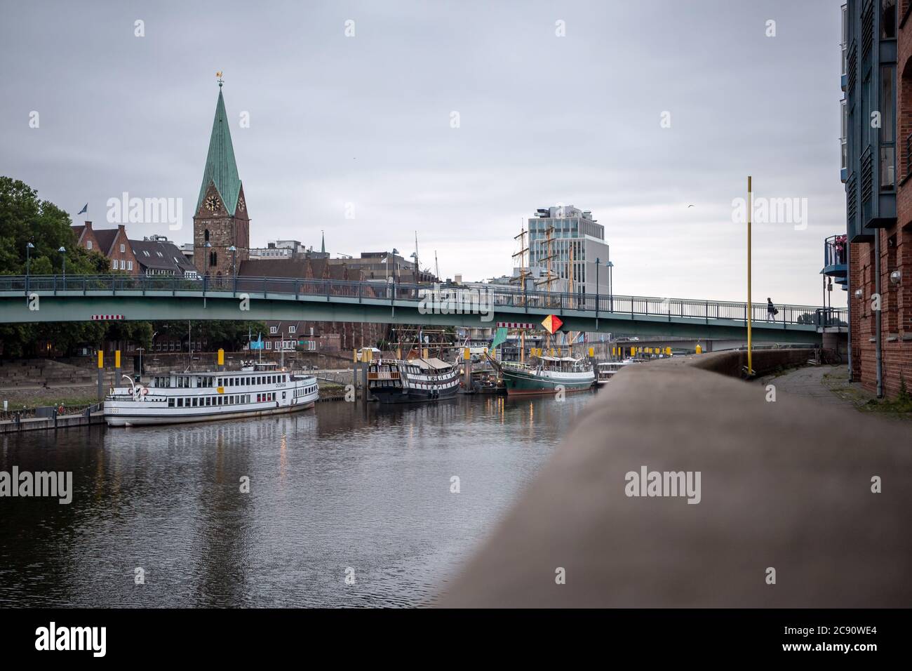 Bremen, Germany. 28th July, 2020. A woman walks across the Teerhof ...
