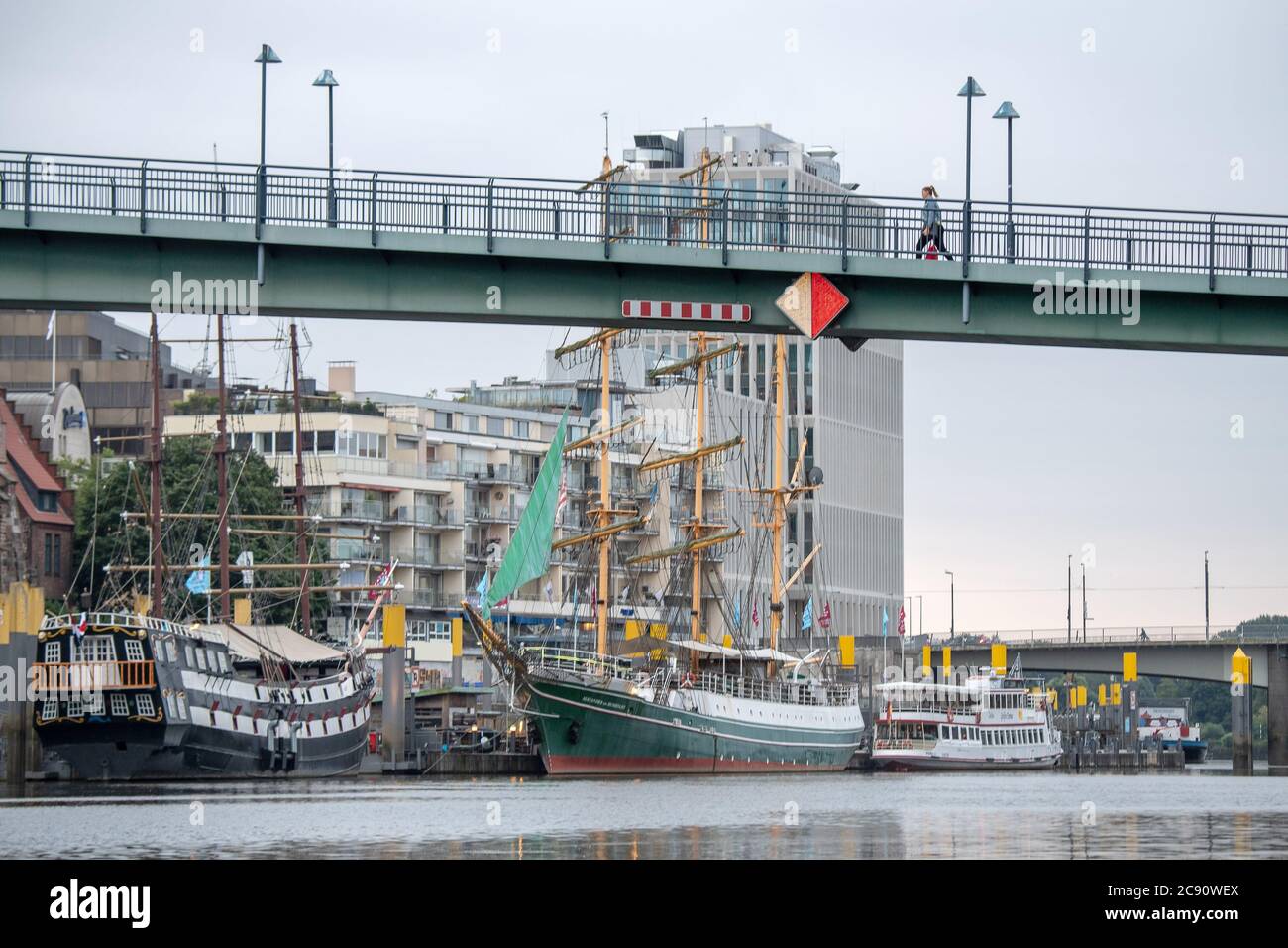 Bremen, Germany. 28th July, 2020. A woman walks across the Teerhof ...