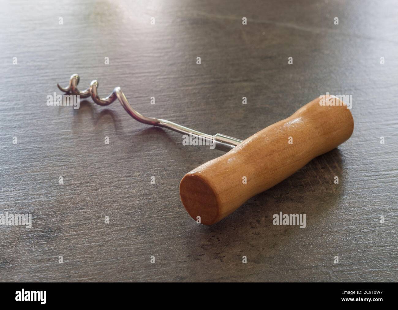 close up simple wooden corkscrew on a grey textured background Stock ...