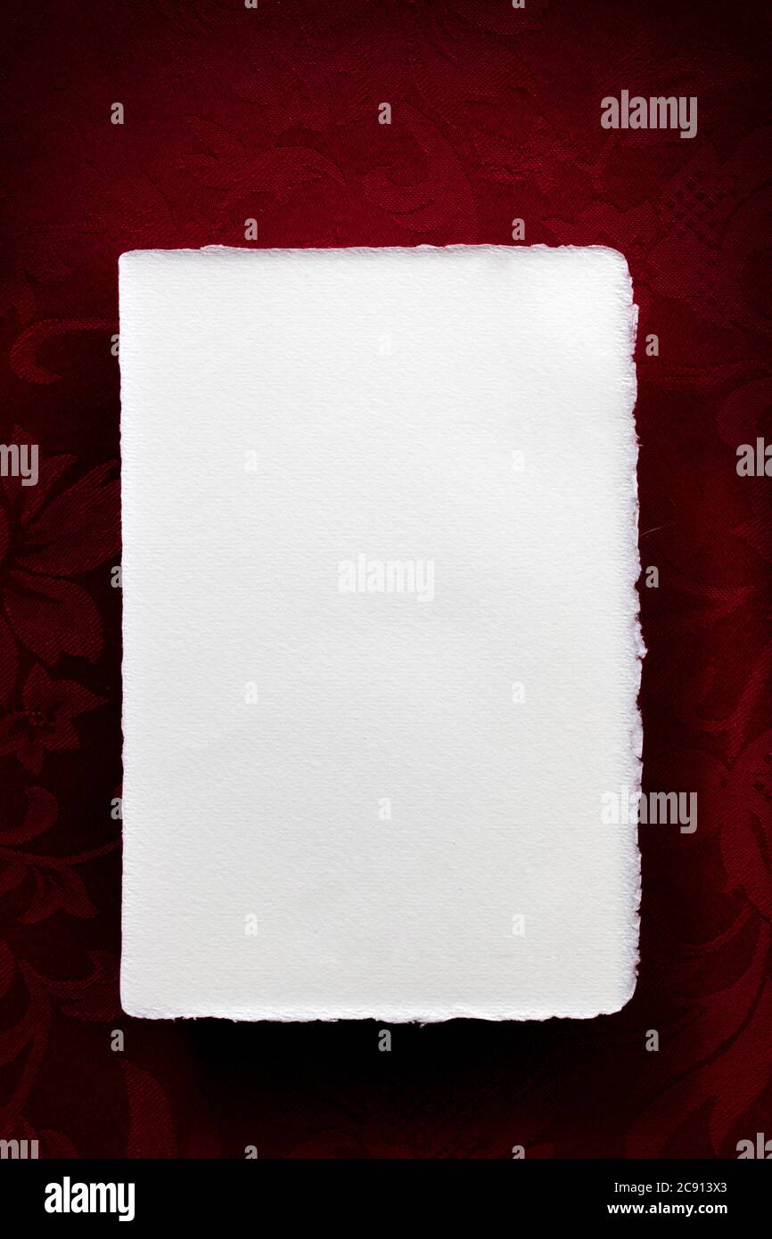 Blank vintage white writing paper over rich red background Stock Photo ...