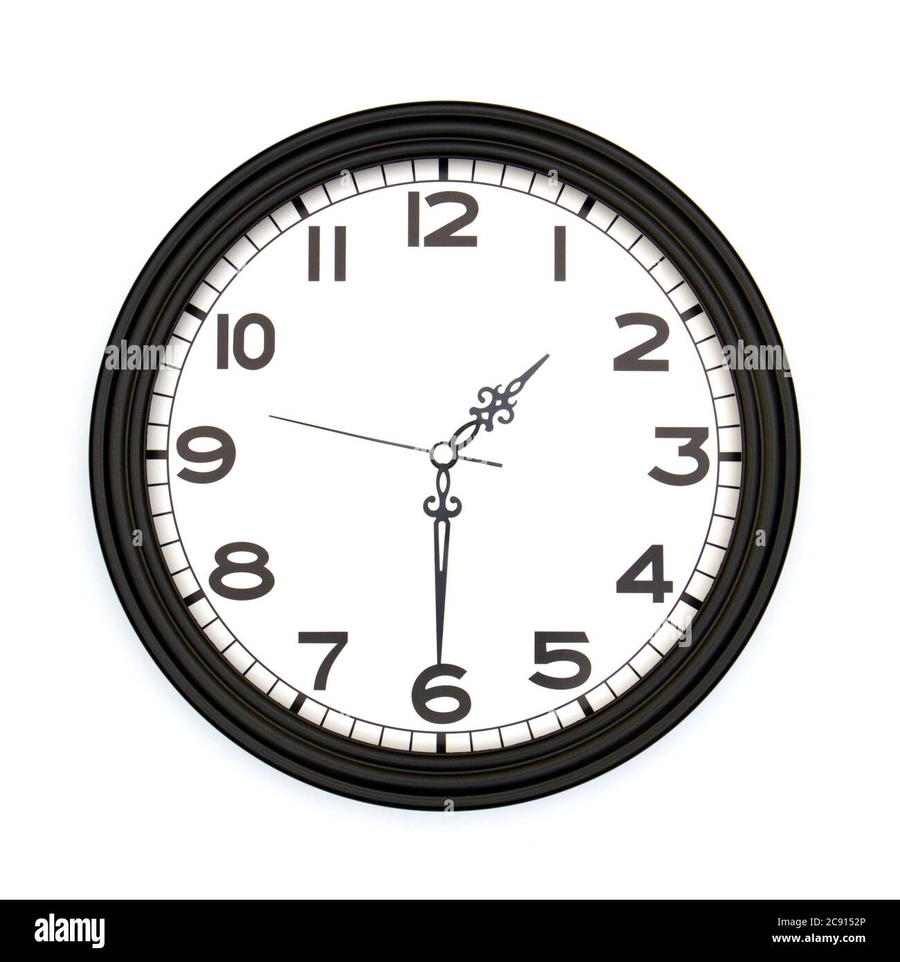 Black round analog wall clock isolated on white background, its half ...