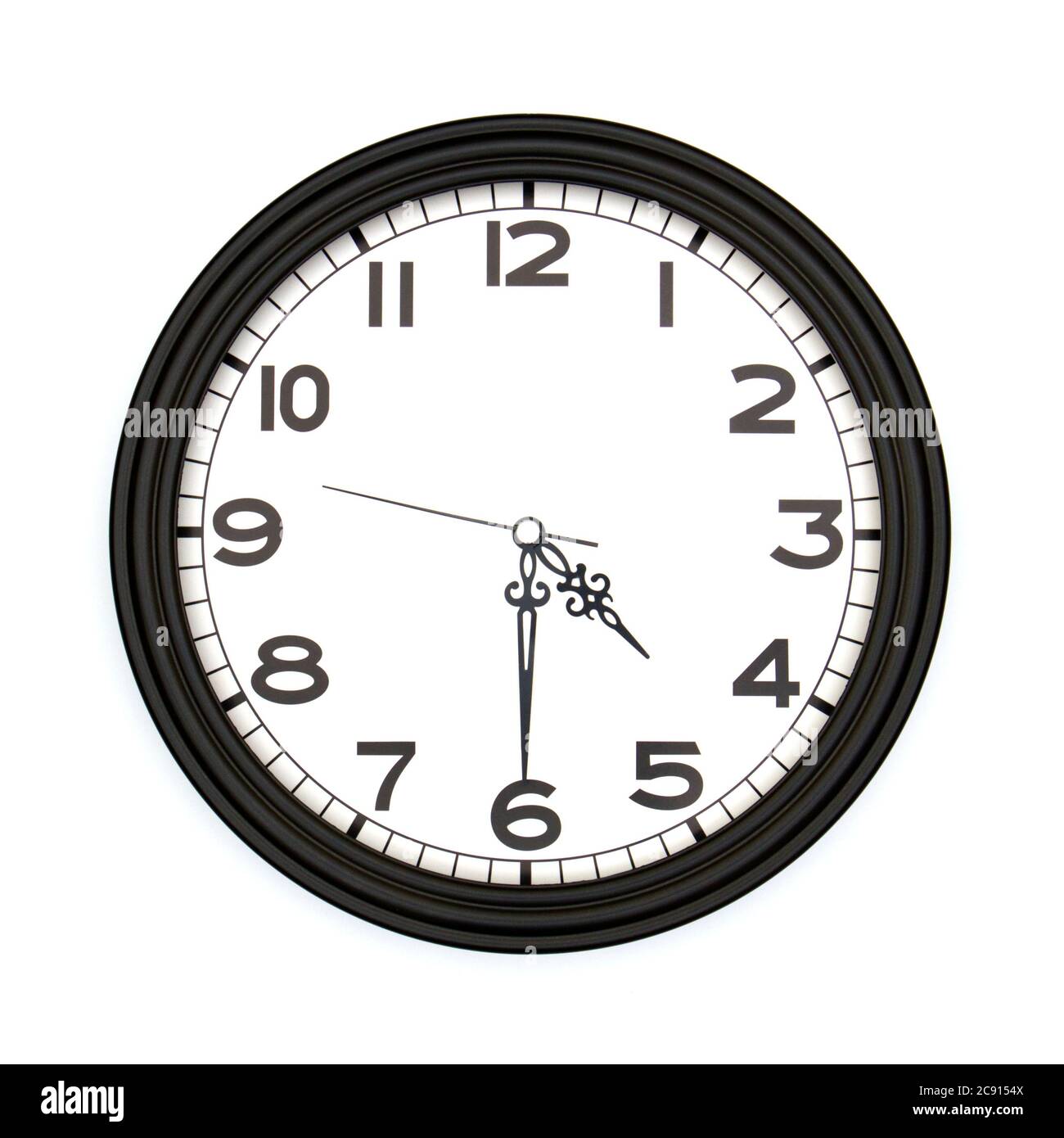 Black round analog wall clock isolated on white background, its half ...