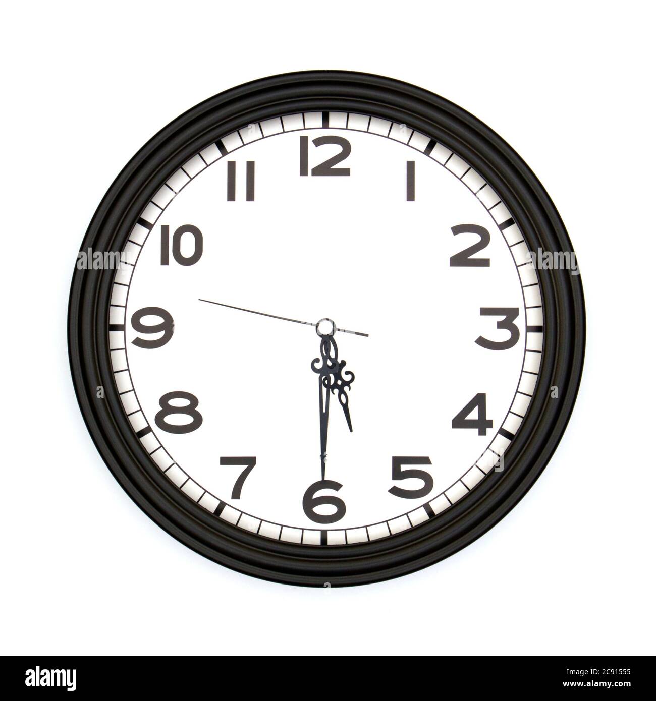 Black round analog wall clock isolated on white background, its half ...