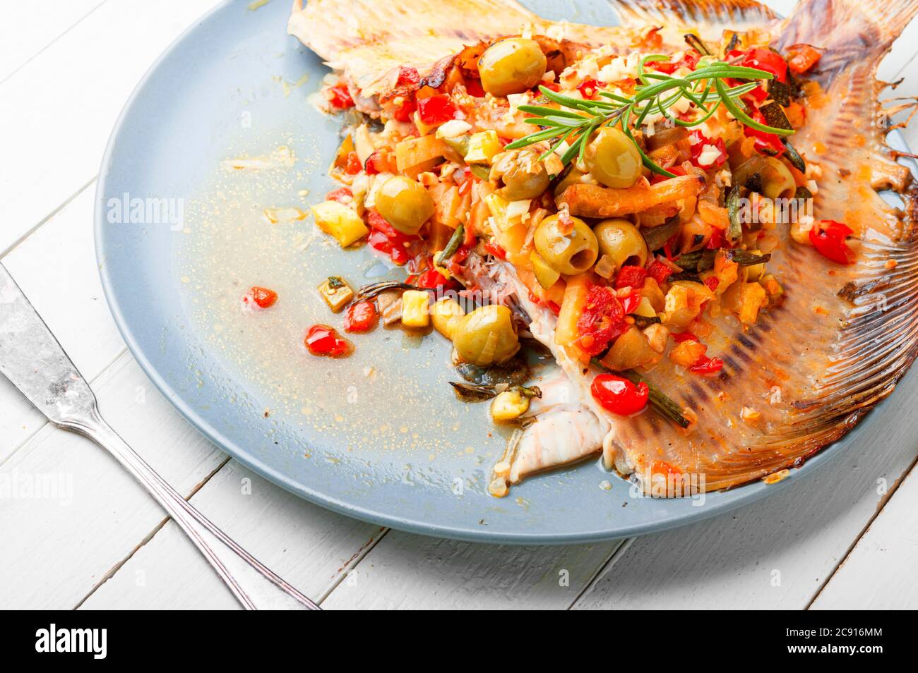 Plaice flounder or flat-fish baked with vegetables.Fried fish with ...