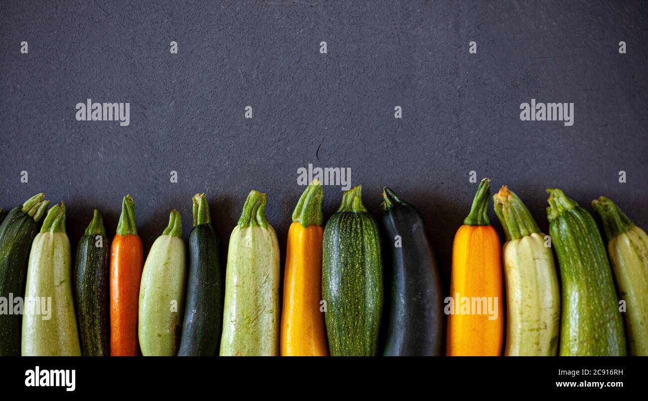 Fresh zucchini of different colors green, yellow, orange, white ...