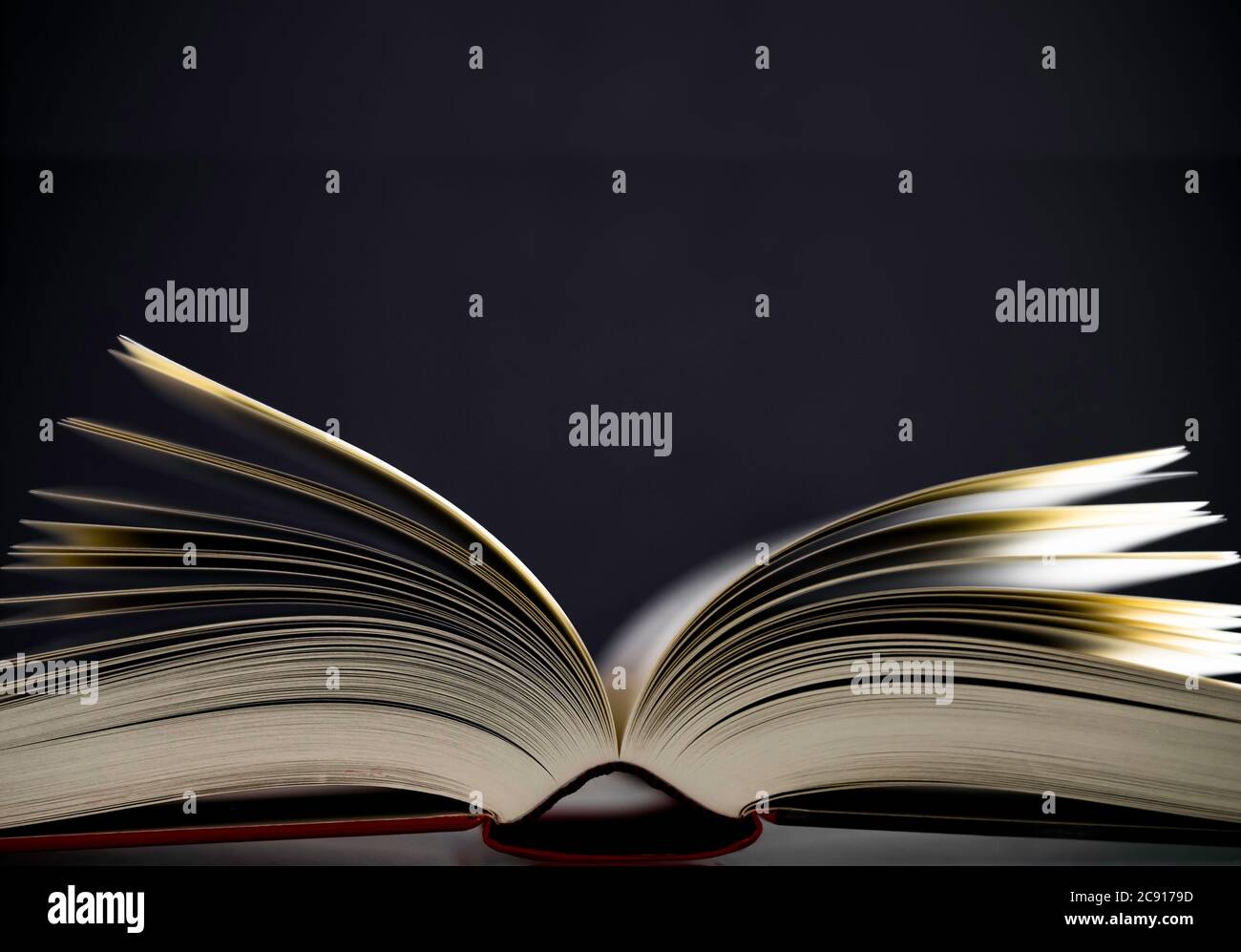 Open book with cover and narrow depth of field on a table with black ...