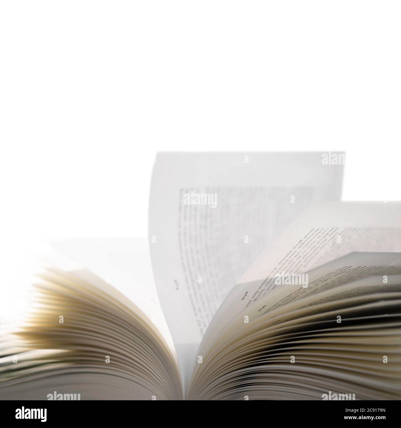 Open book with narrow depth of field isolated on white. Pages flutter ...
