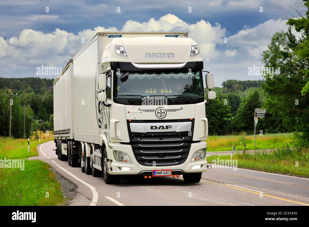 White DAF XF freight transport truck Malinen delivers load along ...