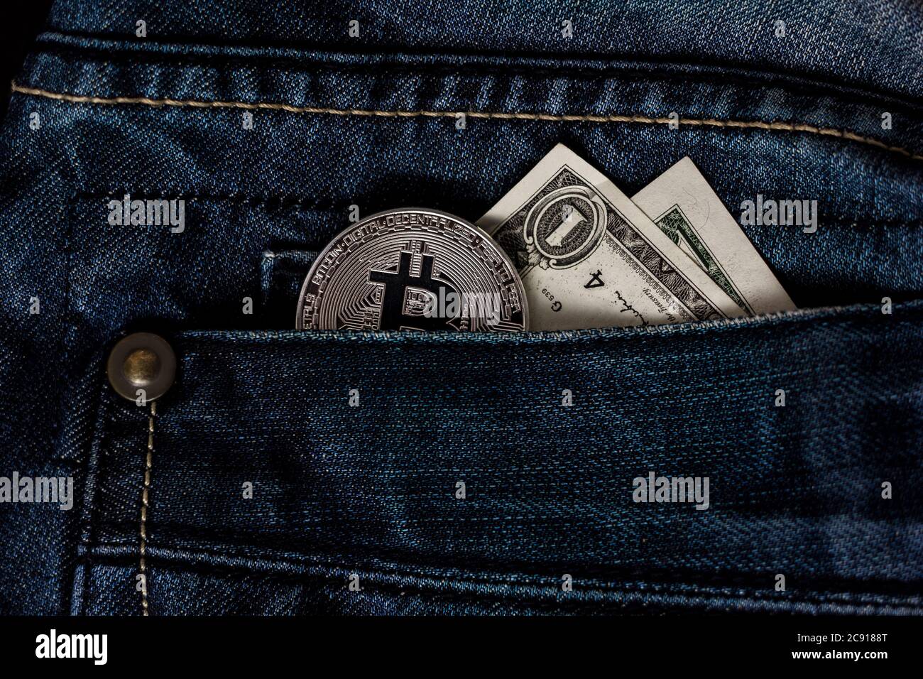 US dollar and bitcoin coin in a jeans pocket Stock Photo - Alamy