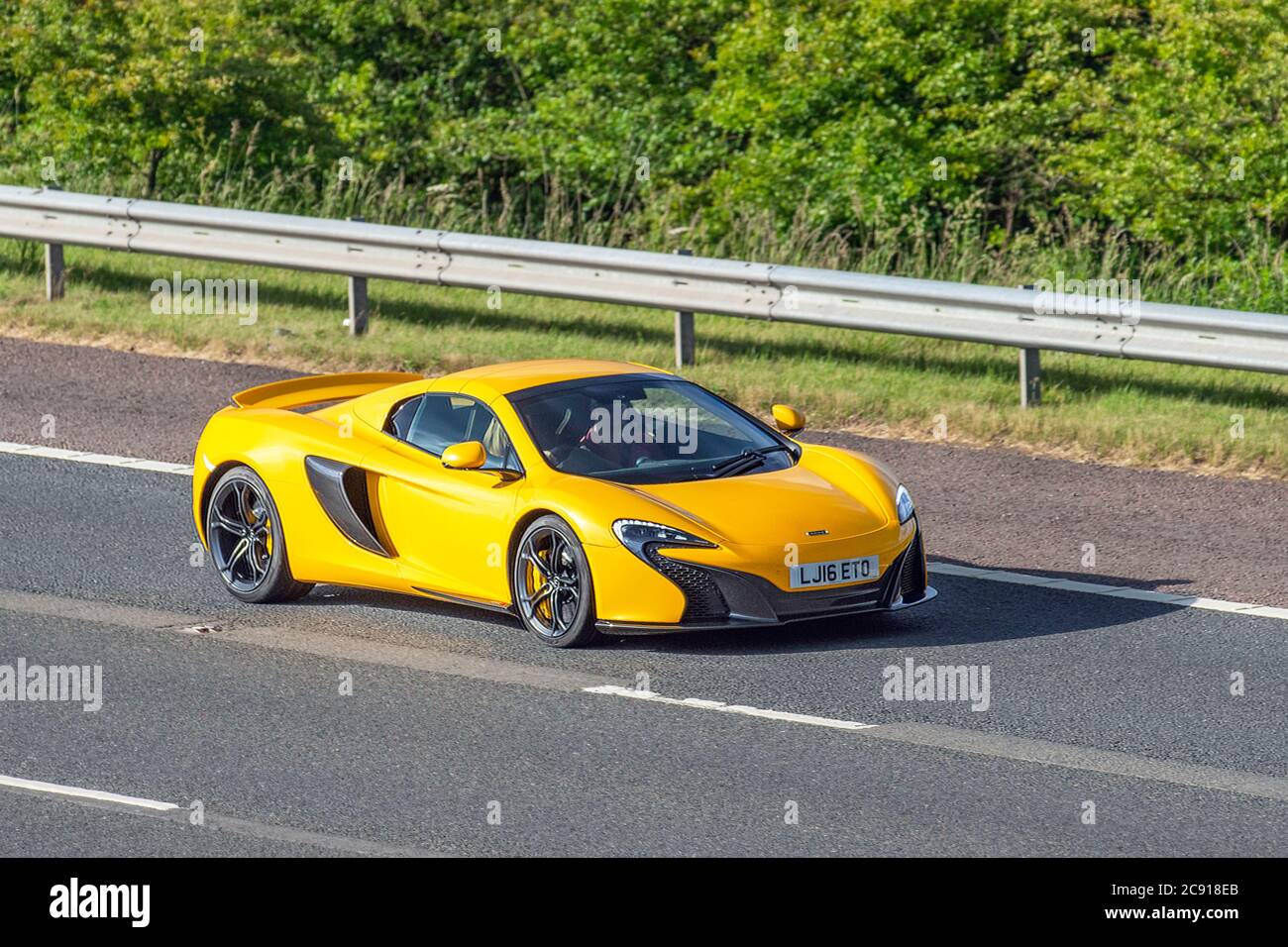 2016 yellow McLaren sports car; Vehicular traffic moving vehicles, cars ...