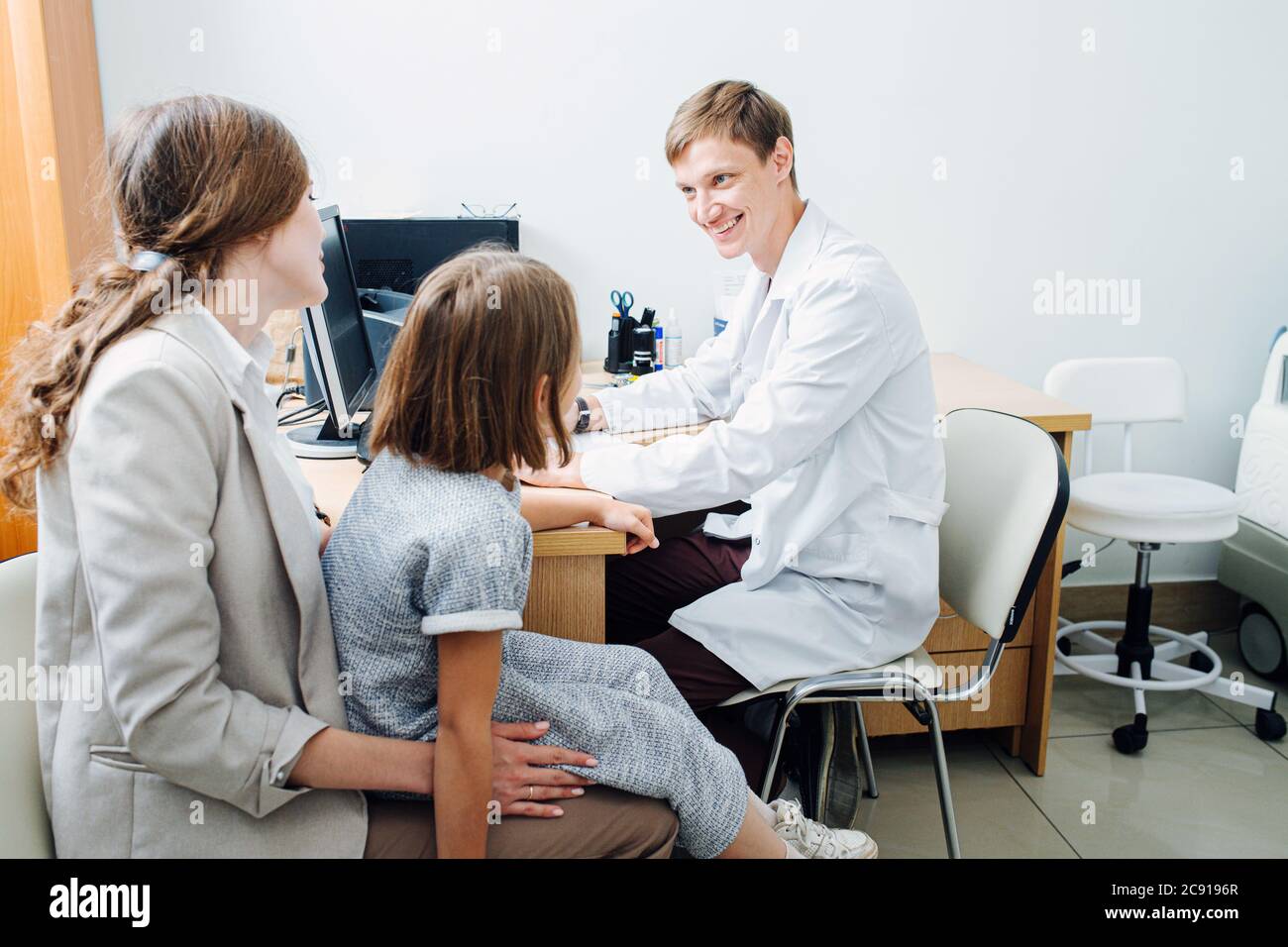 Mother And Daughter Came To Pediatrician For Health Examination Stock