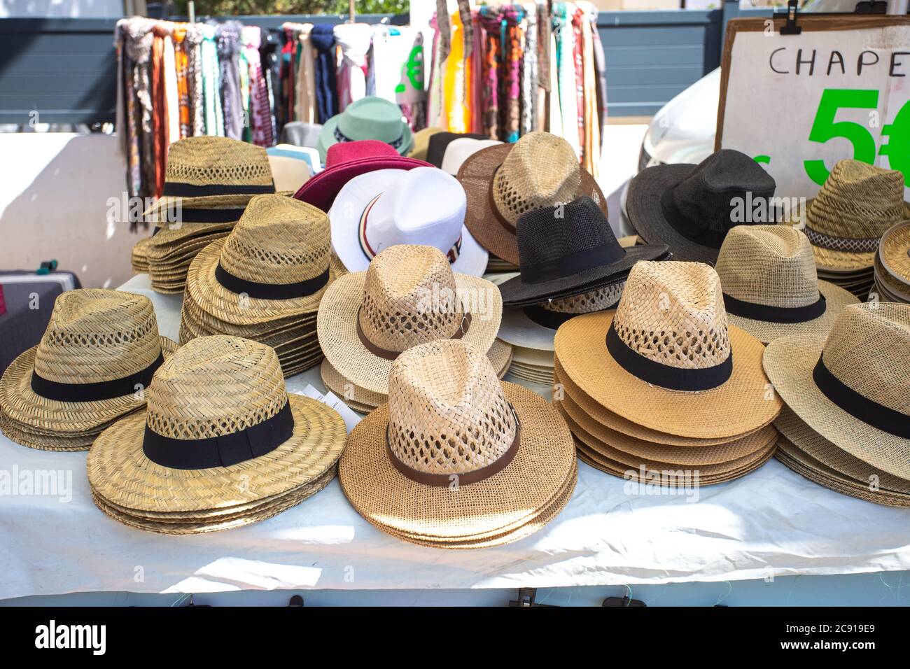 sale of sun hats in a market Stock Photo - Alamy