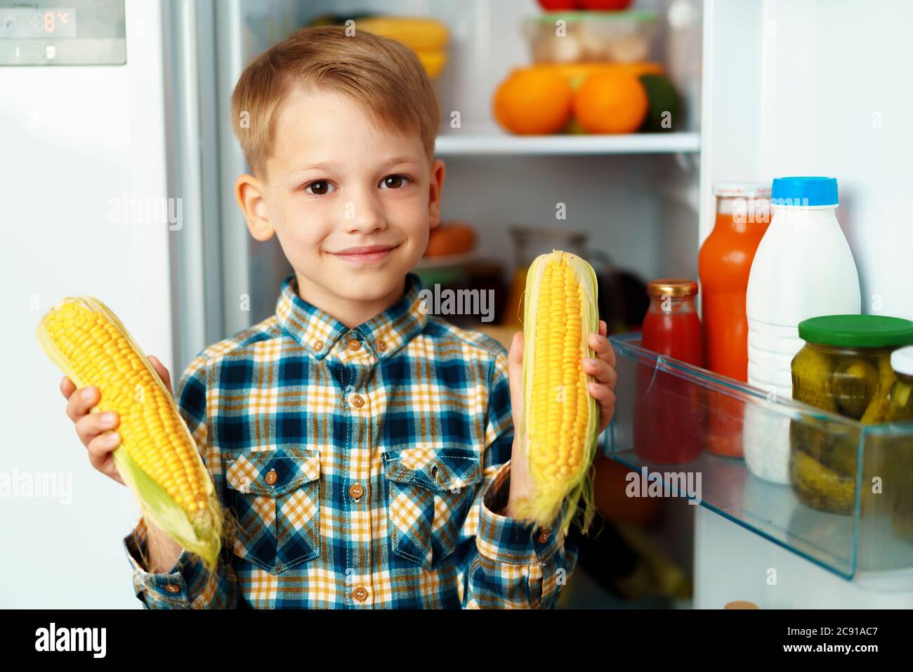 Boy standing in front of open fridge hi-res stock photography and ...